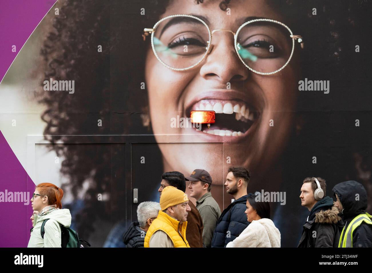 Christmas shoppers and a billboard for a new optician retailer outlet ...