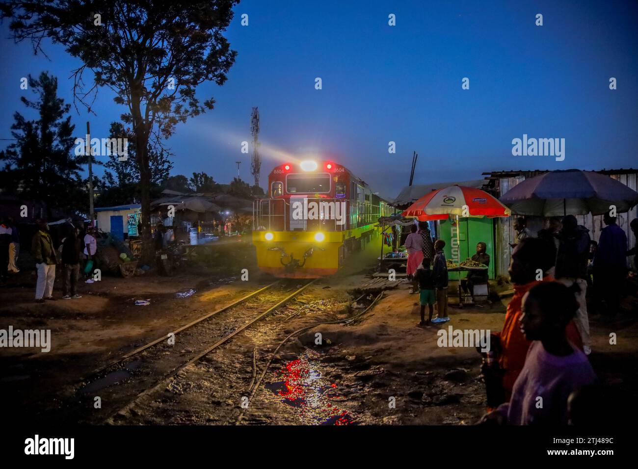 The late evening Nairobi to Kisumu passenger train drives past Kibera ...