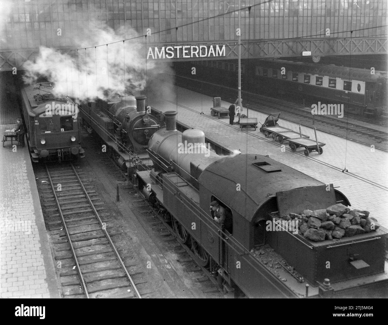 On the right a steam locomotive being shunted by another with on the ...