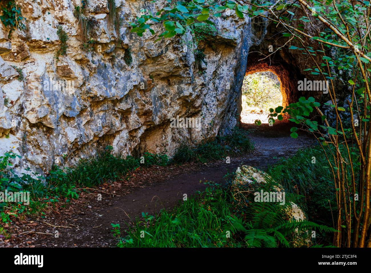 Tunnels carved into the rock allow the continuity of the trail. Las ...