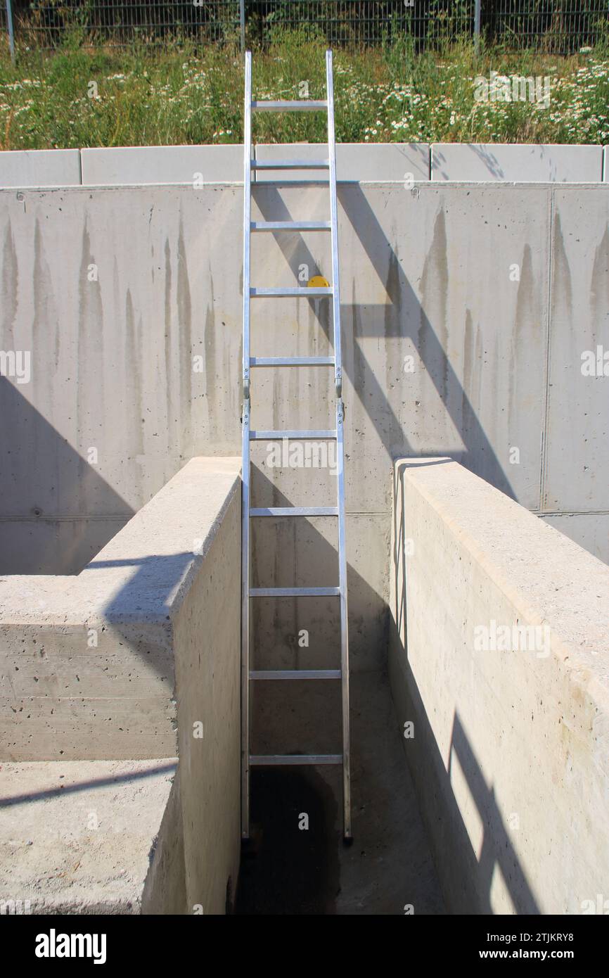 Ladder stands without protection in a sewer in a sewage treatment plant ...