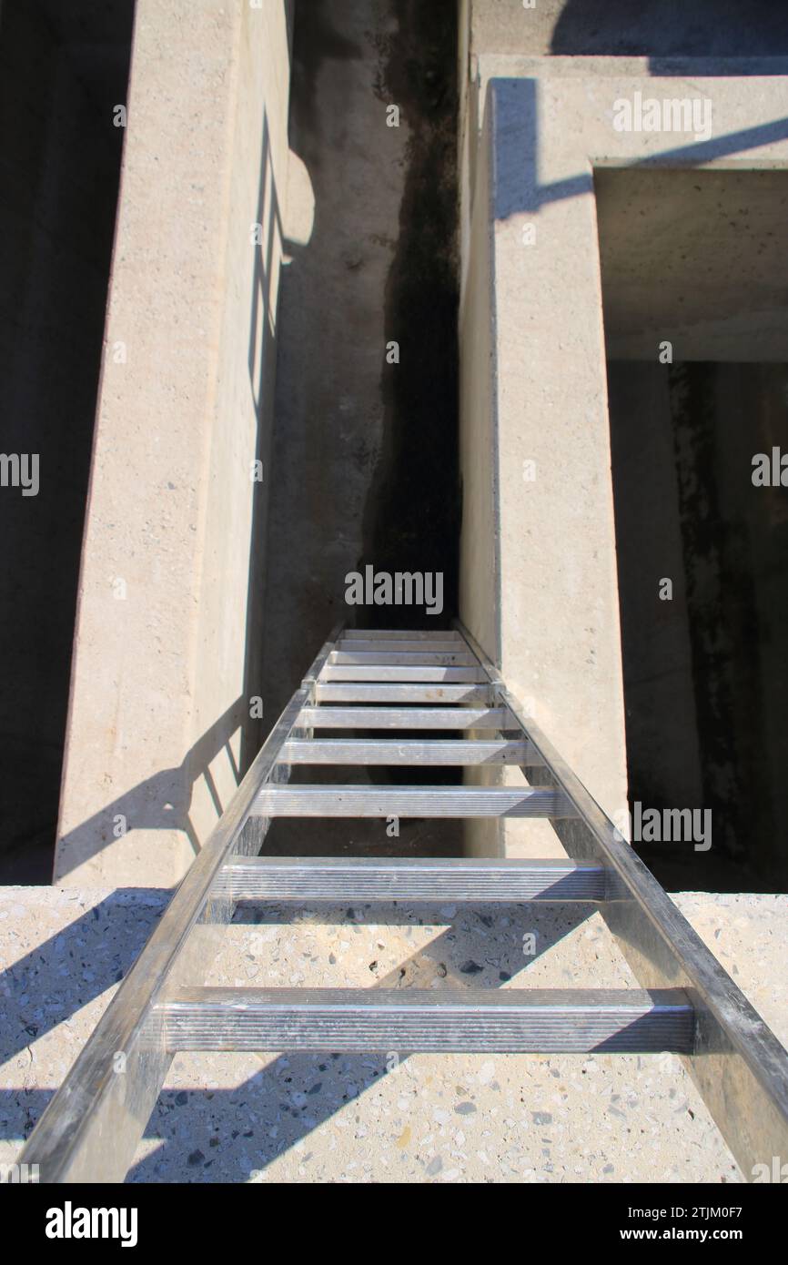 Ladder stands without protection in a sewer in a sewage treatment plant ...