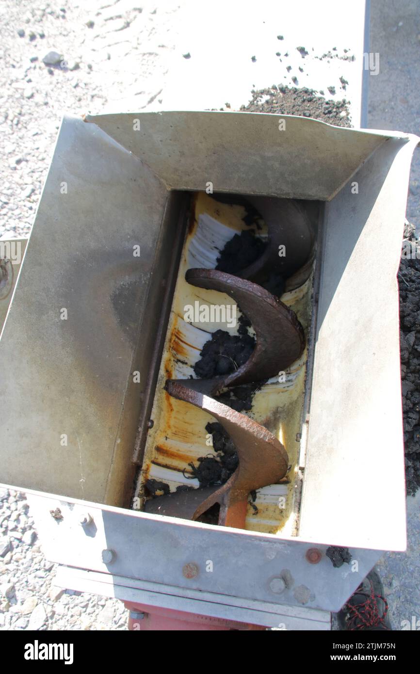 View of a screw conveyor for sewage sludge Stock Photo - Alamy