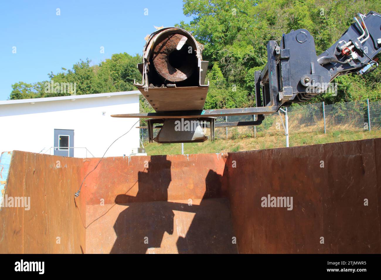 Screw conveyor is tipped into a container with a wheel loader Stock ...