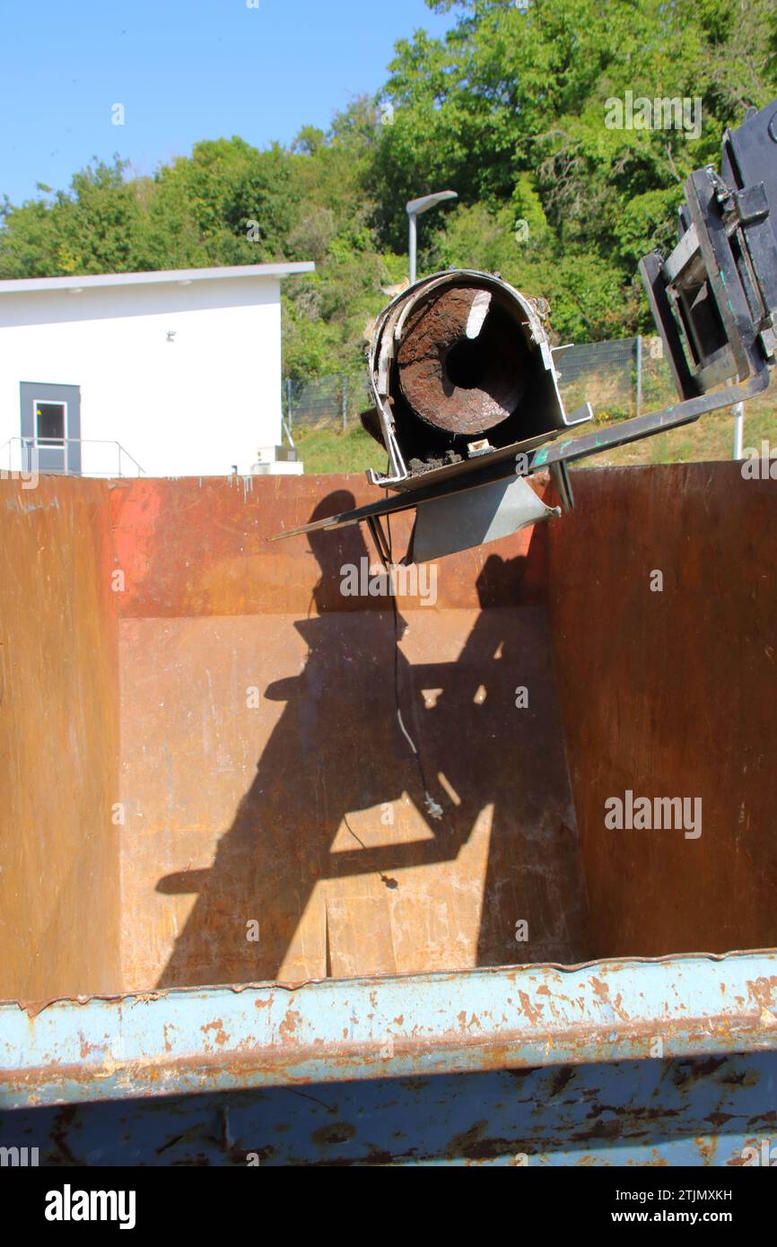 Screw conveyor is tipped into a container with a wheel loader Stock ...