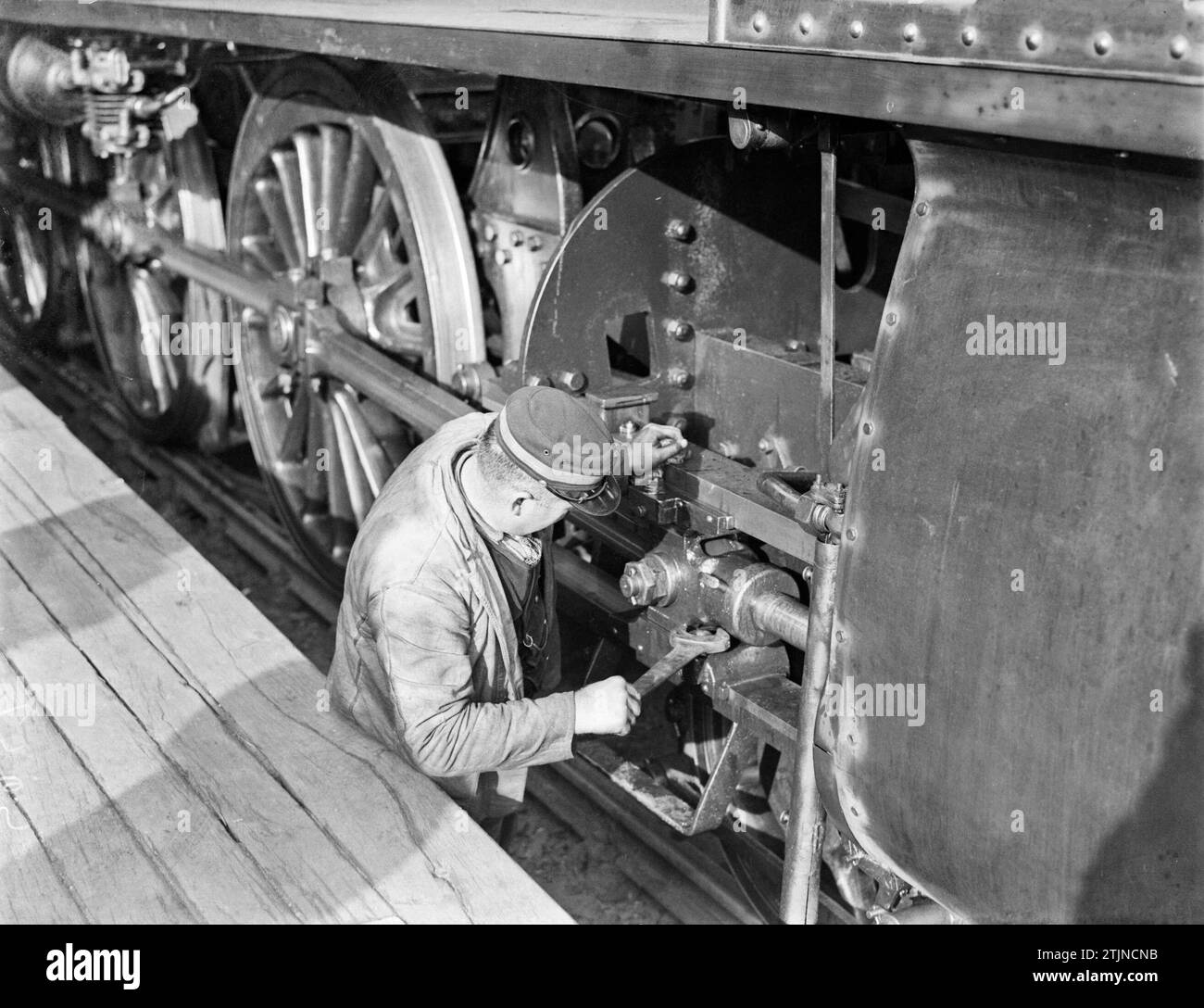 Engineer performs maintenance on a locomotive ca. 1932 Stock Photo - Alamy