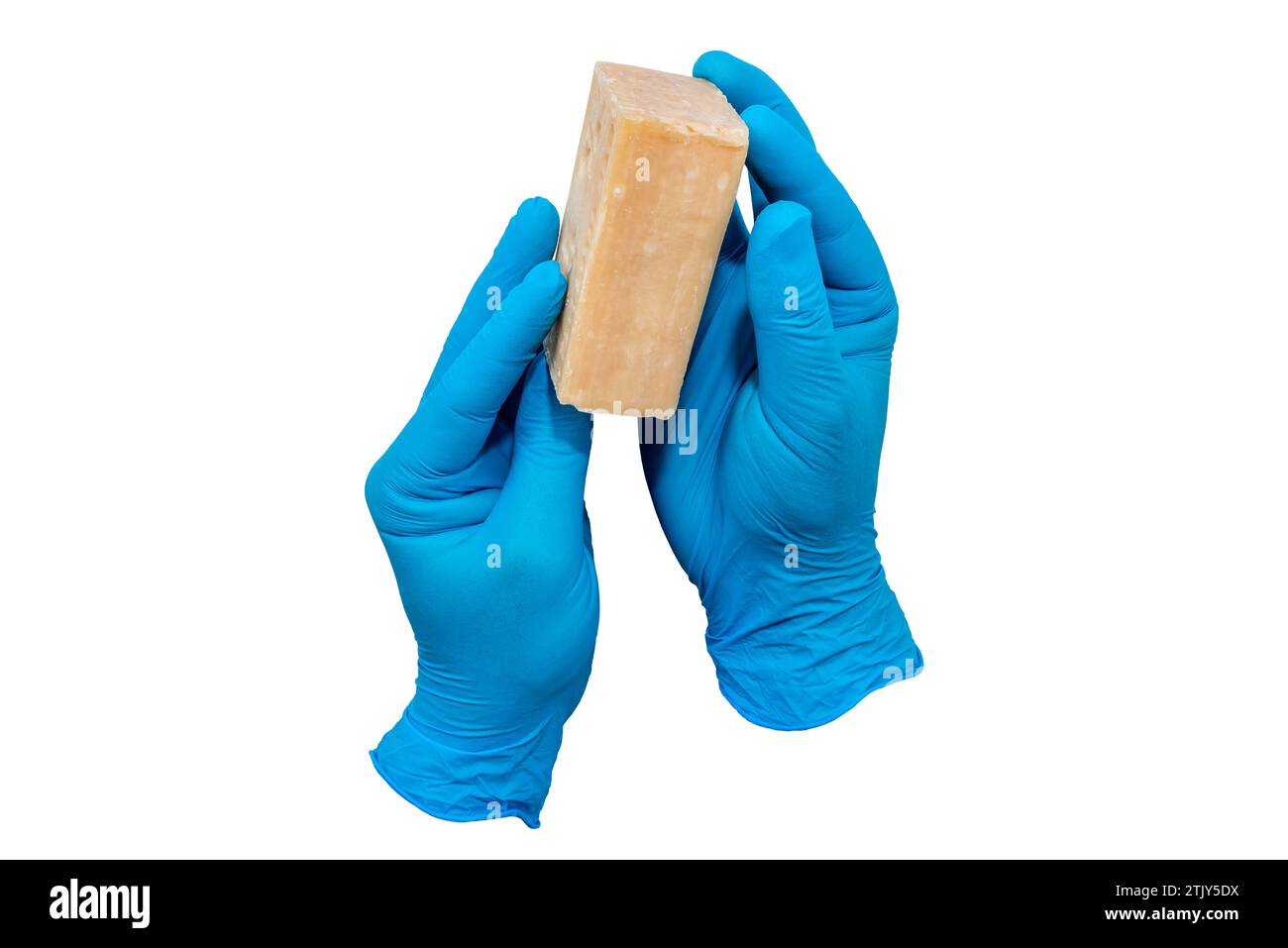 Hands in blue rubber gloves hold a piece of toilet soap on a white ...