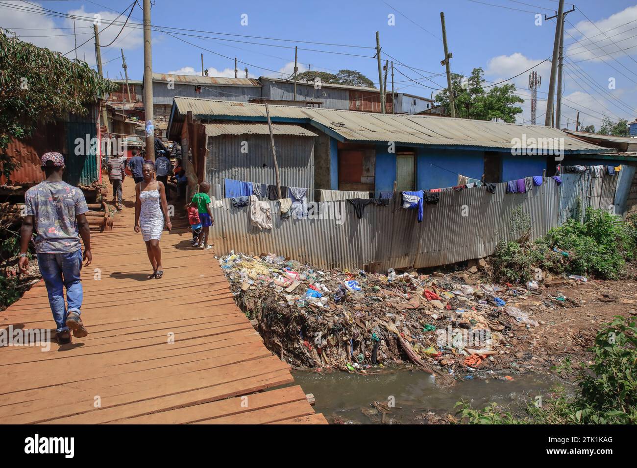 Residents walk past the streets in Kibera Slum, Nairobi. A view through ...