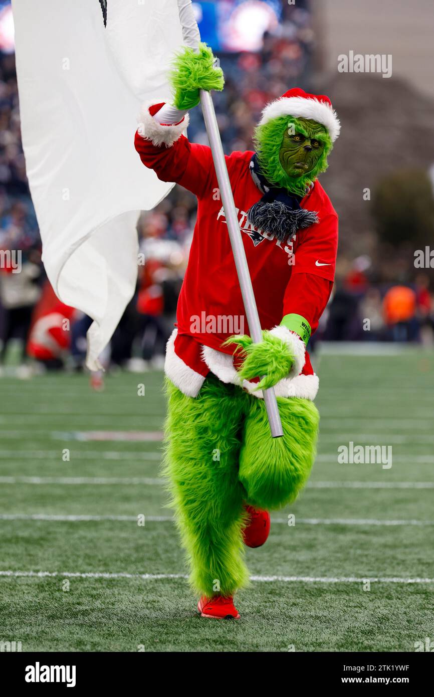 A person dressed as the Grinch runs with a flag during player ...