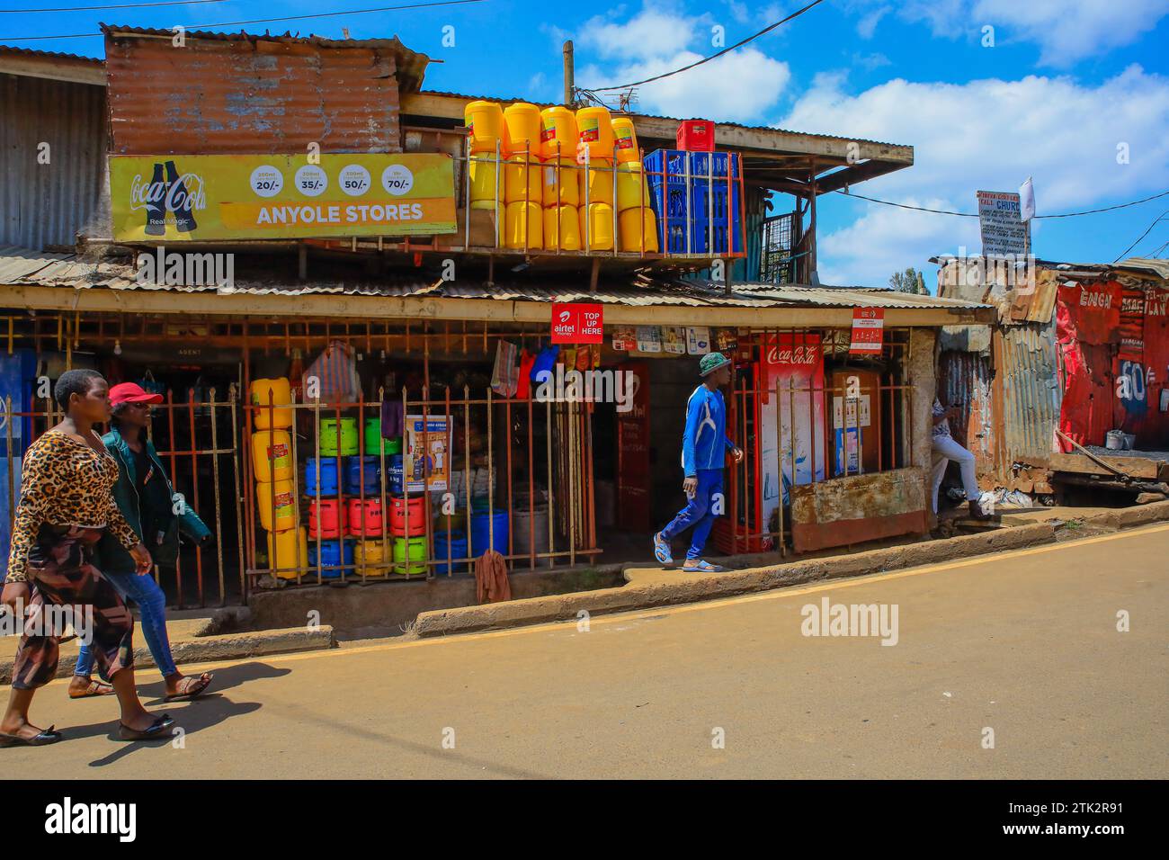 Residents walk past the streets in Kibera Slum, Nairobi. A view through ...