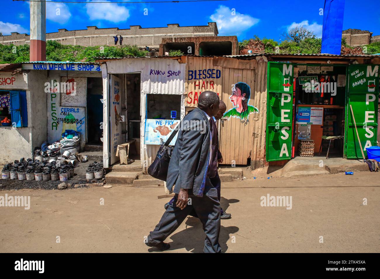 Residents walk past the streets in Kibera Slum, Nairobi. A view through ...