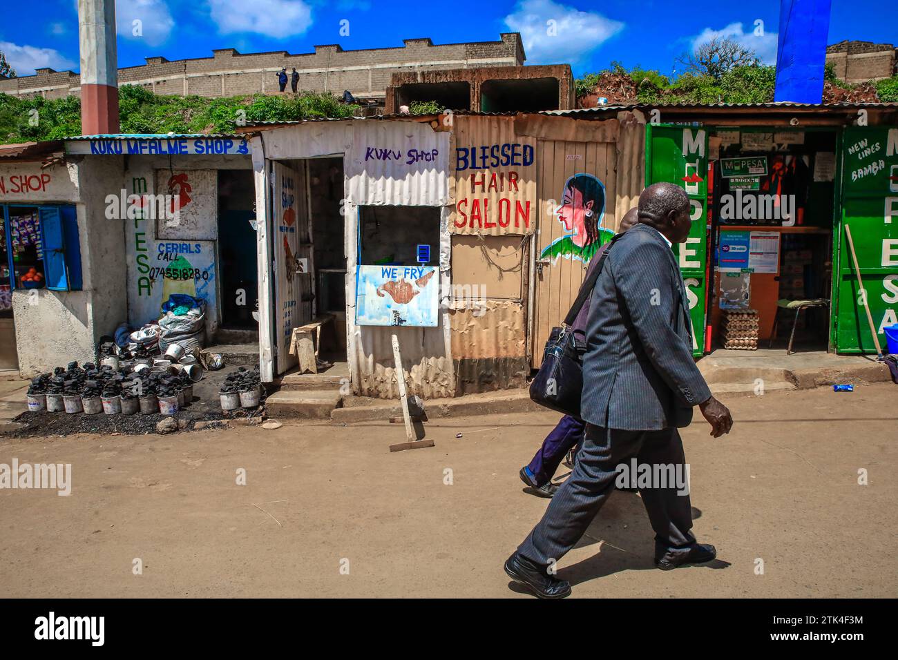Residents walk past the busy streets in Kibera Slum, Nairobi. A view ...
