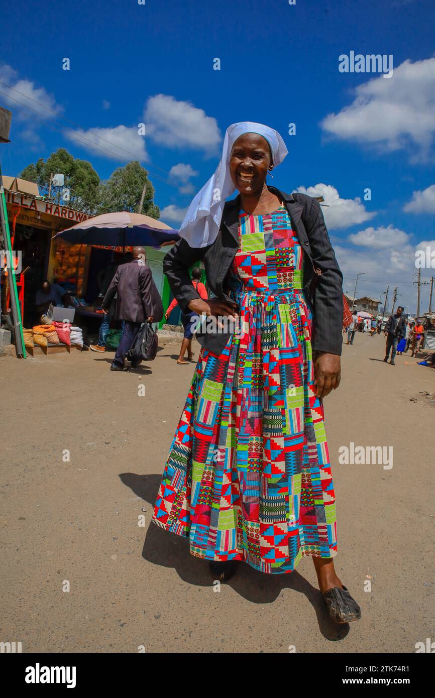 A woman dressed in a colorful ankara is posed for a photo in Kibera ...