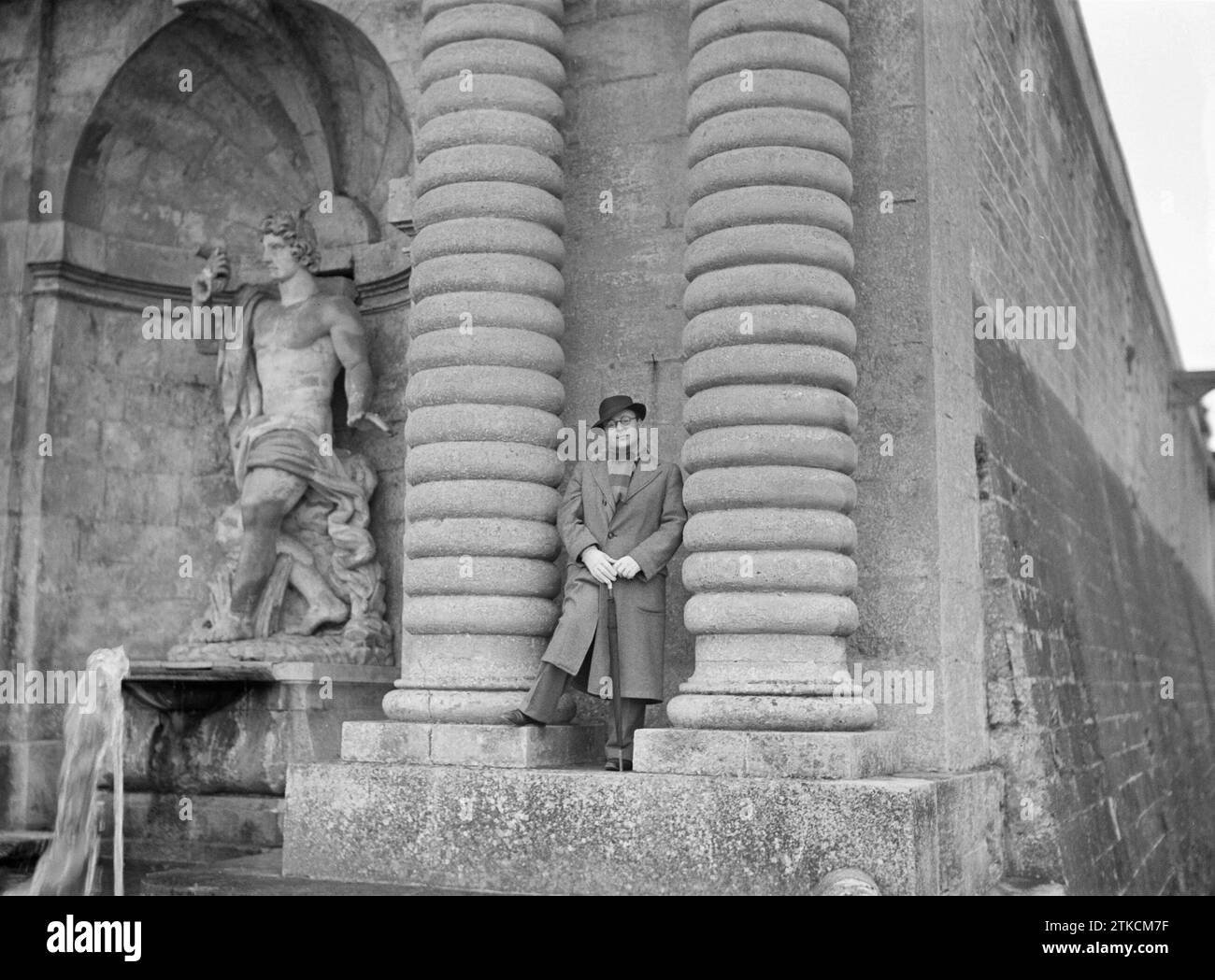 Unknown man between two columns near a statue in a niche in the wall of ...