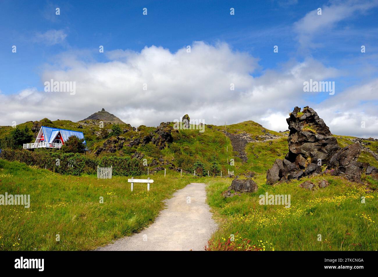 Blue roofed farm building below the volcanic mountain Stock Photo - Alamy