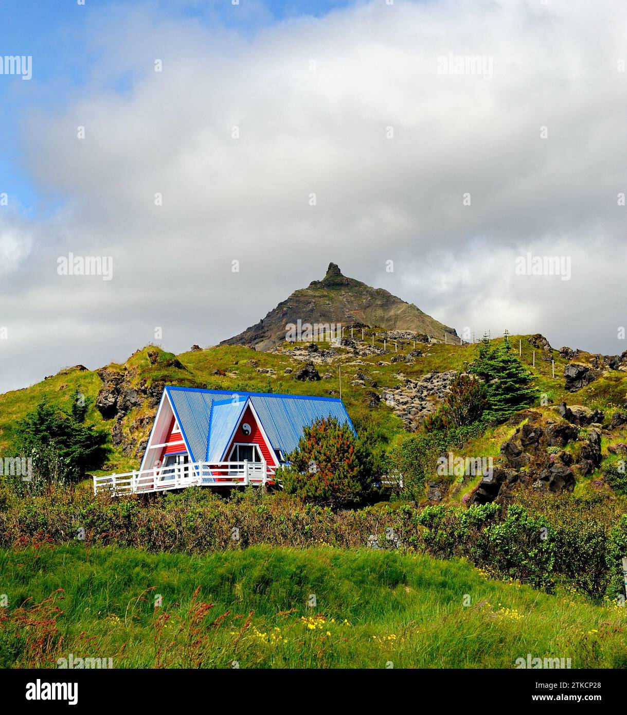 Blue roofed farm building below the volcanic mountain Stock Photo - Alamy