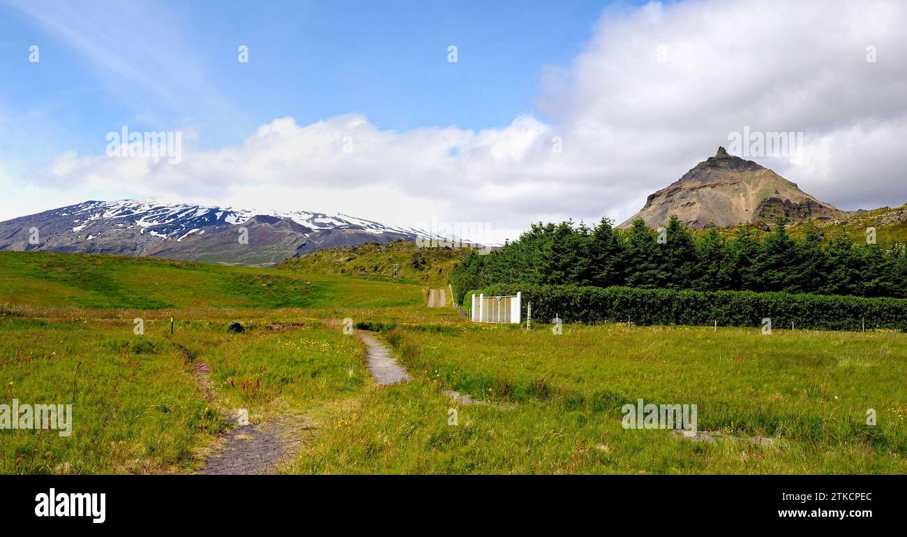 Farmland and farm building below the volcanic mountain Stock Photo - Alamy