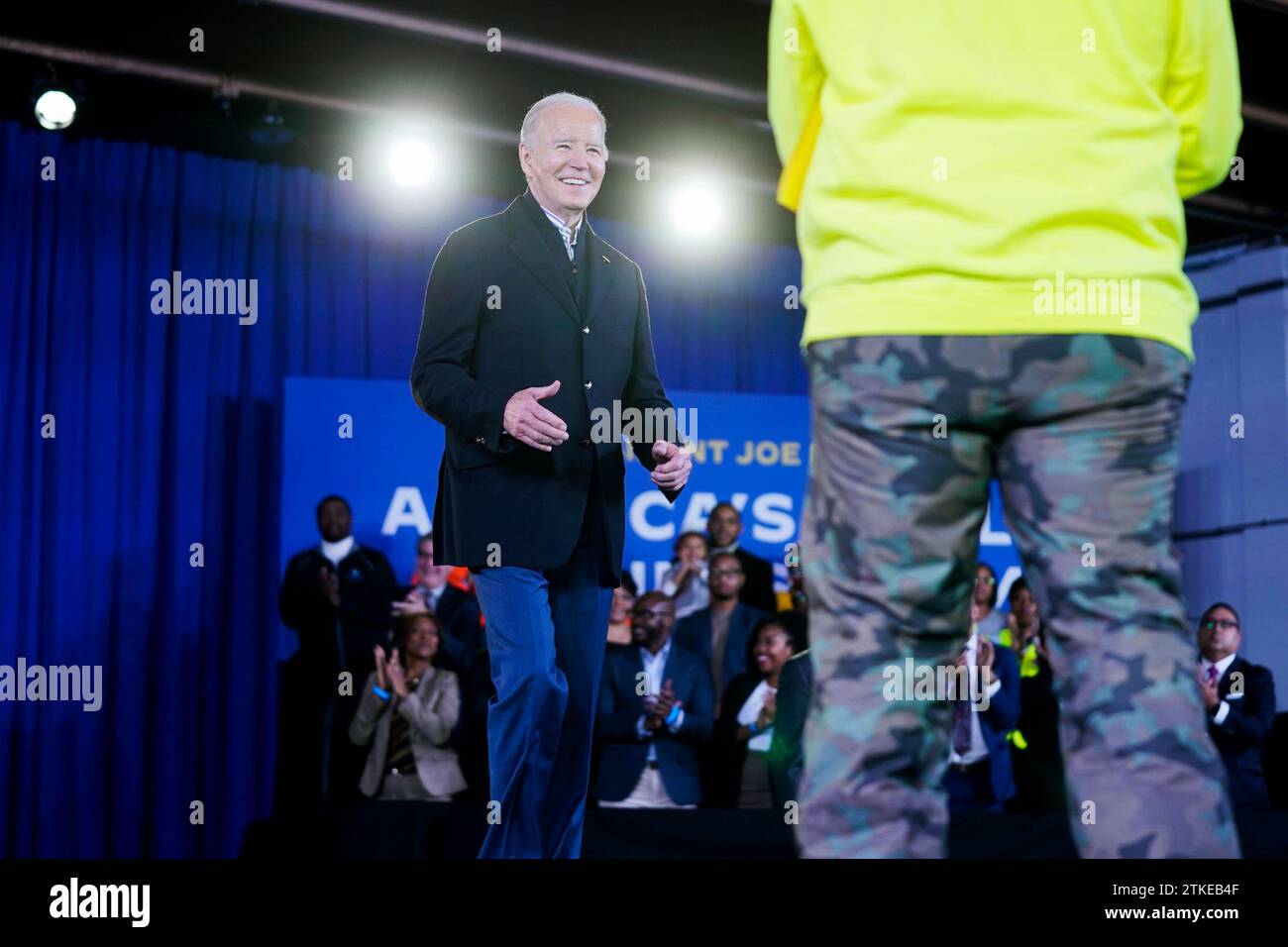 President Joe Biden walks to shake hands with Rashawn Spivey, CEO of ...