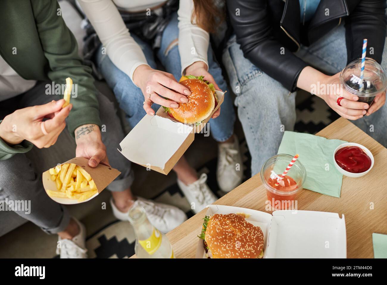 Friends Eating Fast Food Stock Photo - Alamy