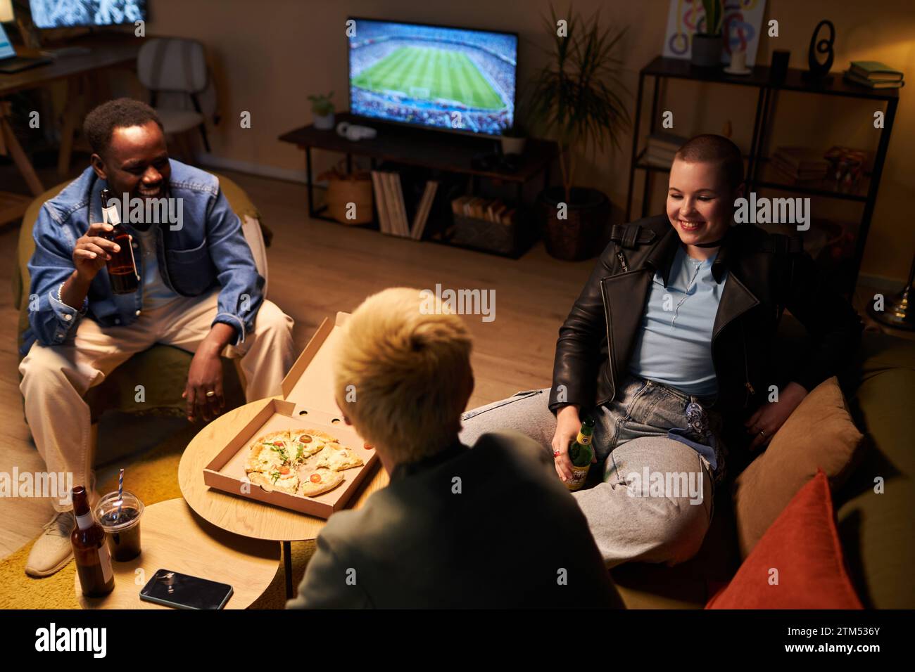 Young Friends Hanging Out at Home and Watching Football Stock Photo - Alamy