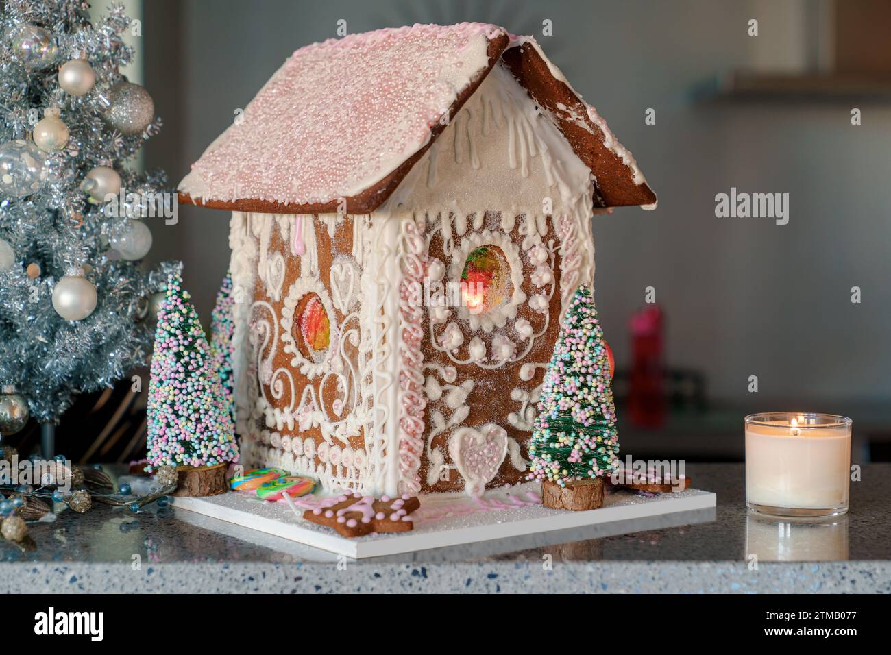 Gingerbread house with white and pink icing. Landscape horizontal side ...