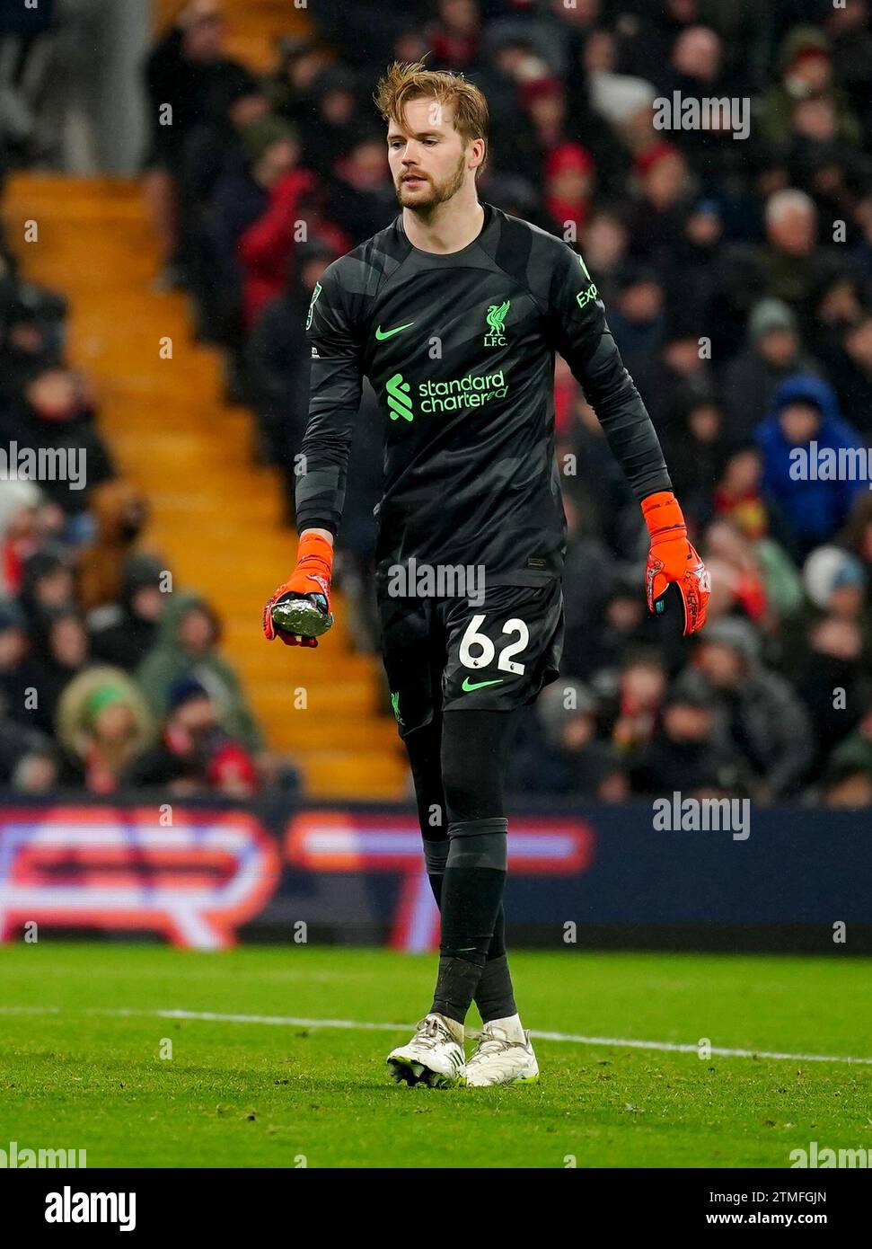 Liverpool goalkeeper Caoimhin Kelleher removes a pie that was thrown ...