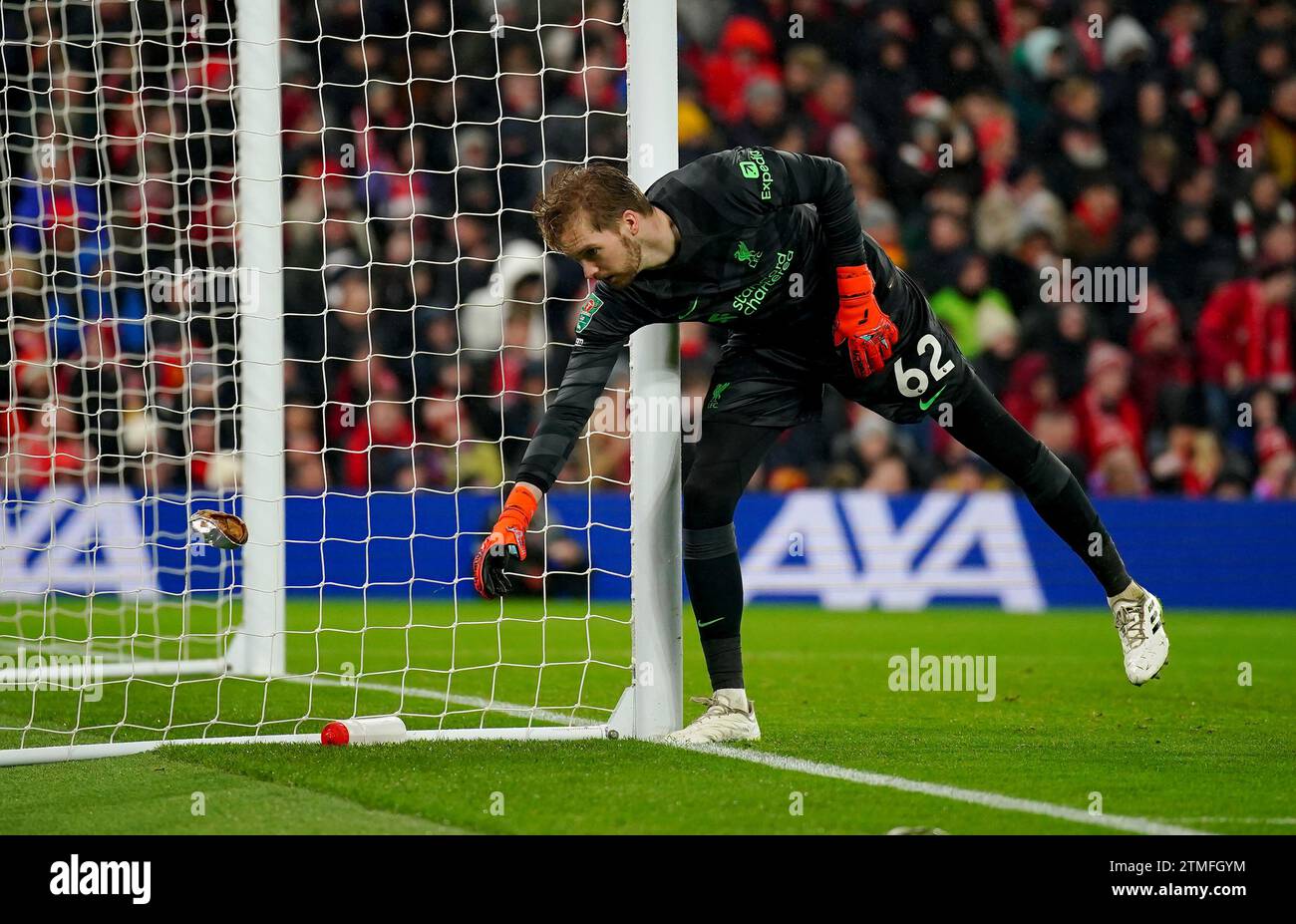 Liverpool goalkeeper Caoimhin Kelleher removes a pie that was thrown ...