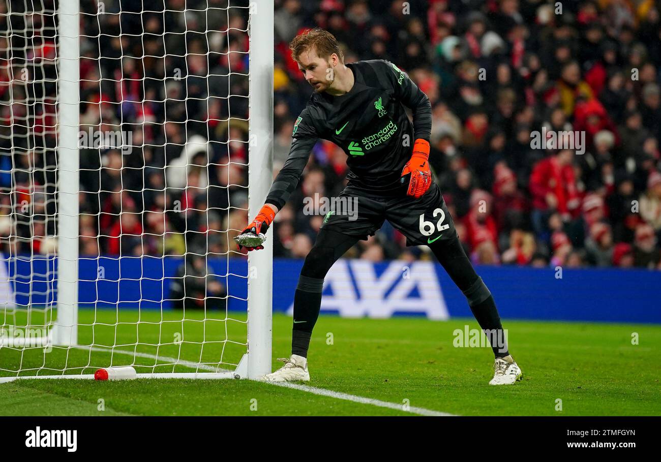 Liverpool goalkeeper Caoimhin Kelleher removes a pie that was thrown ...