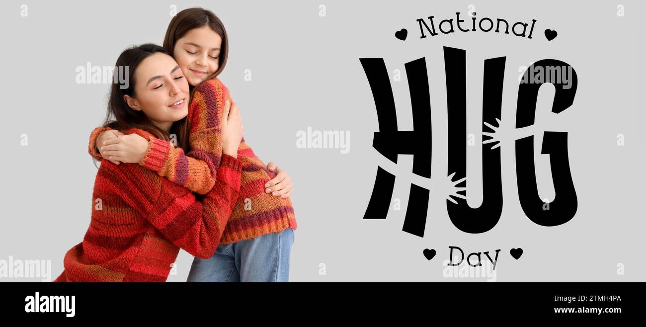 Portrait of hugging little girl and her mother on grey background ...