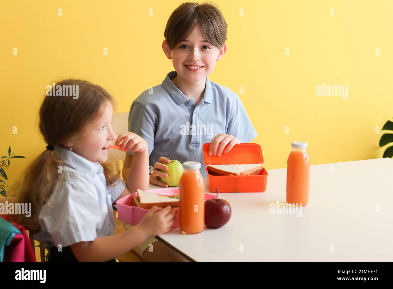 School boy and girl drink juice hi-res stock photography and images - Alamy