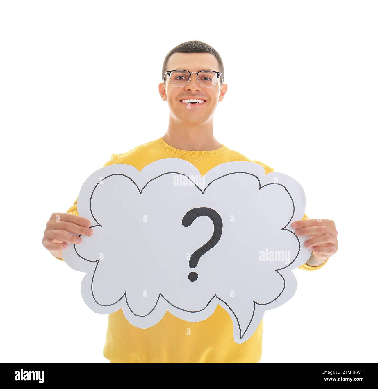 Young man holding speech bubble with question mark on white background ...