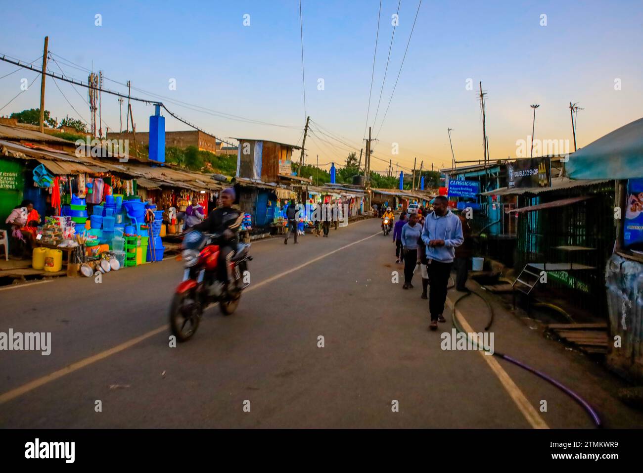 Pedestrians walk past the busy streets in Kibera Slum of Nairobi, Kenya ...