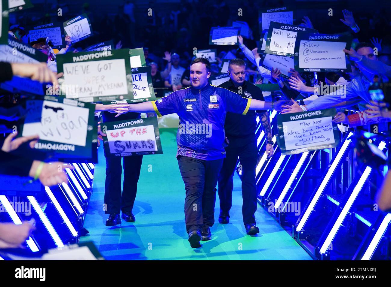 Luke Littler walks out to play Christian Kist (not pictured) on day six ...