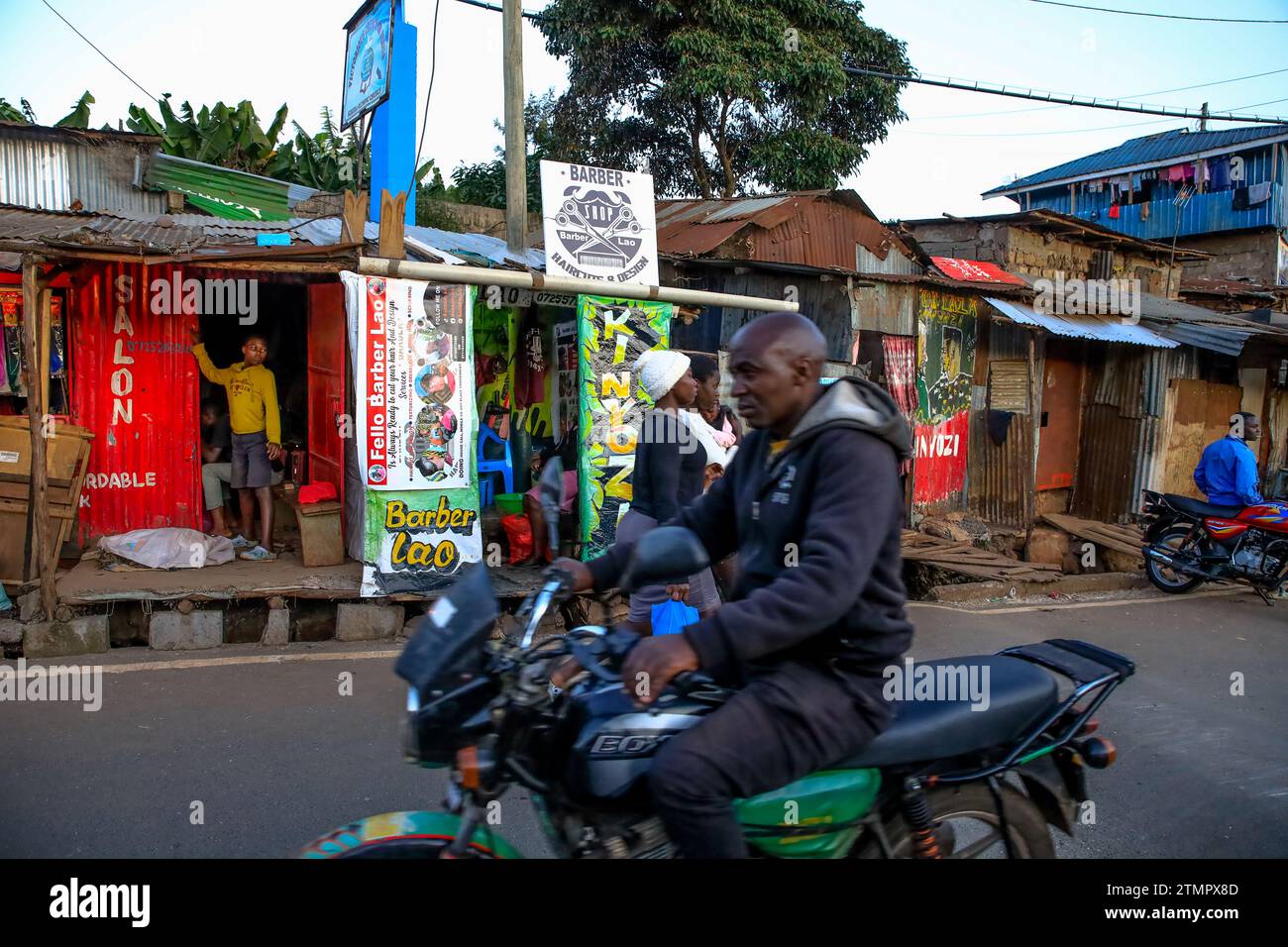 Pedestrians walk past the busy streets in Kibera Slum of Nairobi, Kenya ...