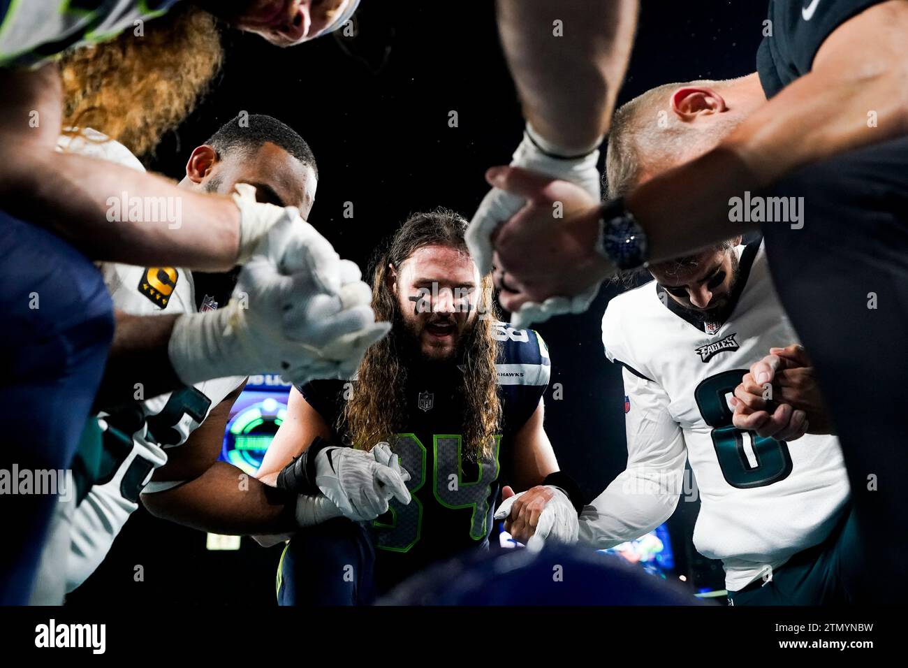 Seattle Seahawks tight end Colby Parkinson leads a group of players and ...