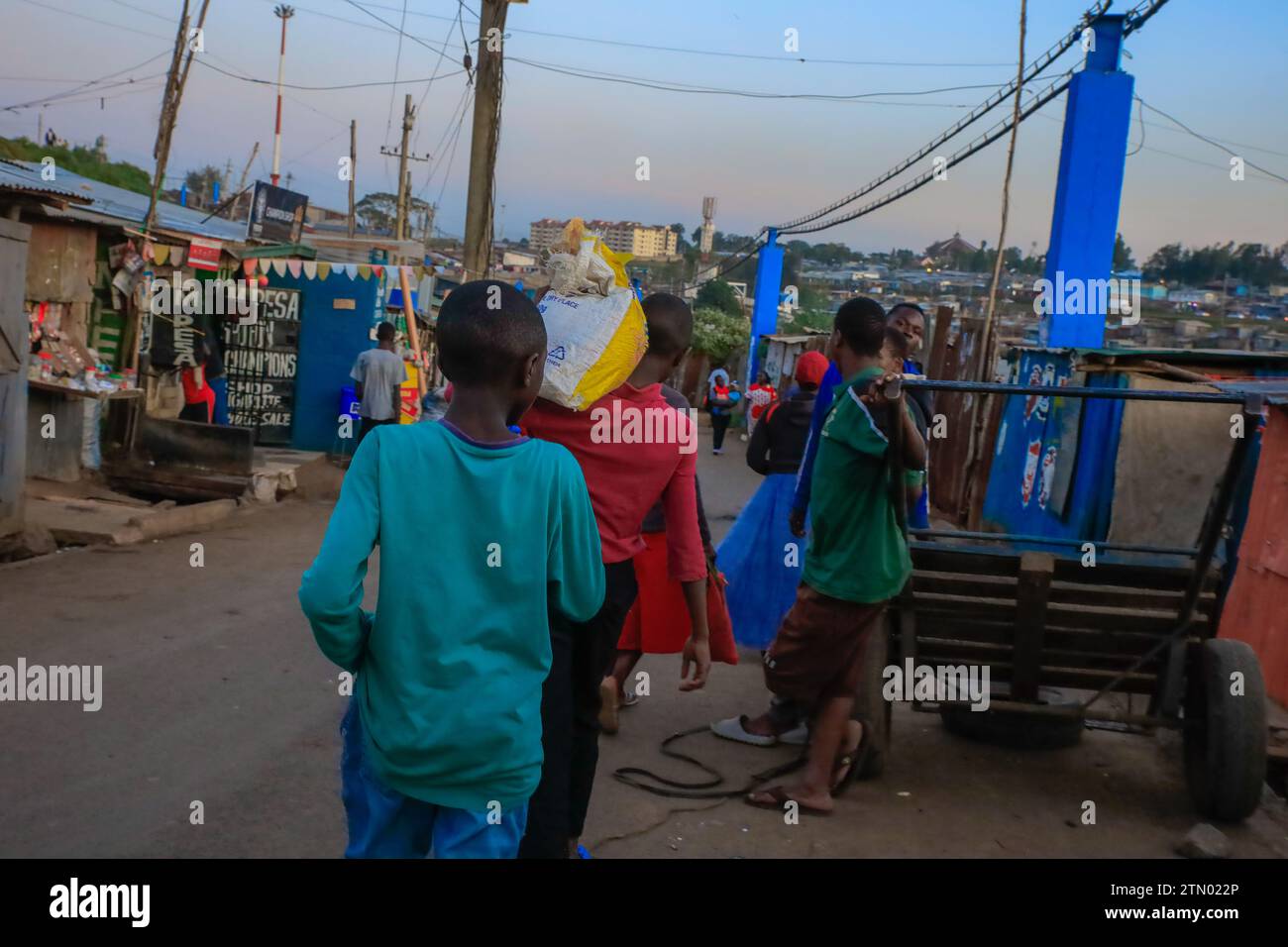 Residents walk past the busy streets in Kibera Slum, Nairobi. A view ...