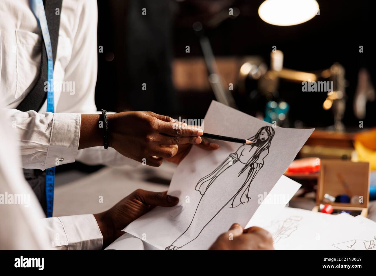 Professional dressmakers designing comissioned wedding dress for future ...