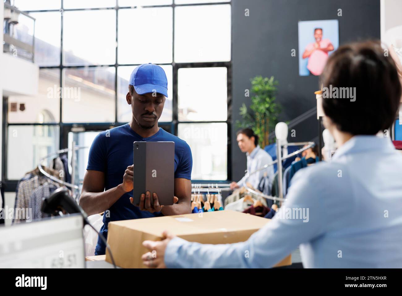 African american courier taking photo of employee with tablet computer ...