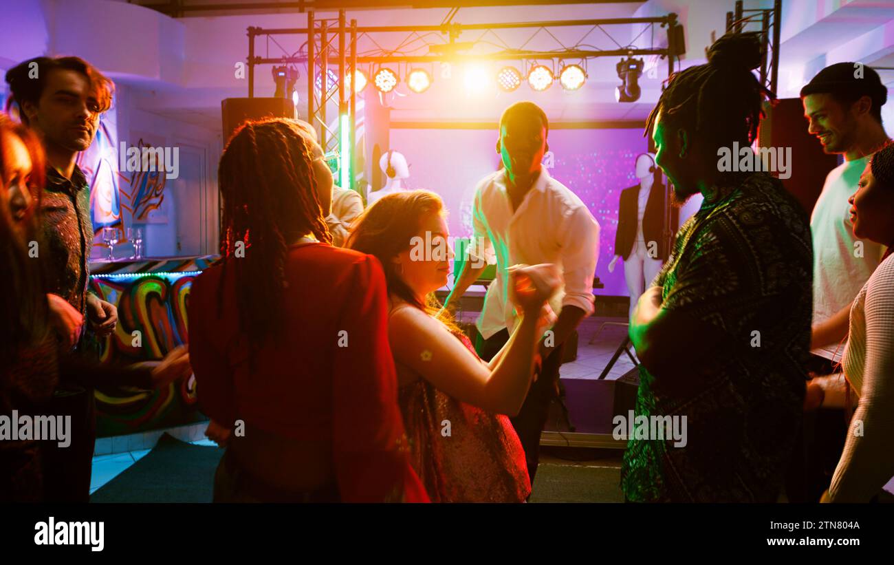 POV of funky people dancing around and feeling happy at club, enjoying ...