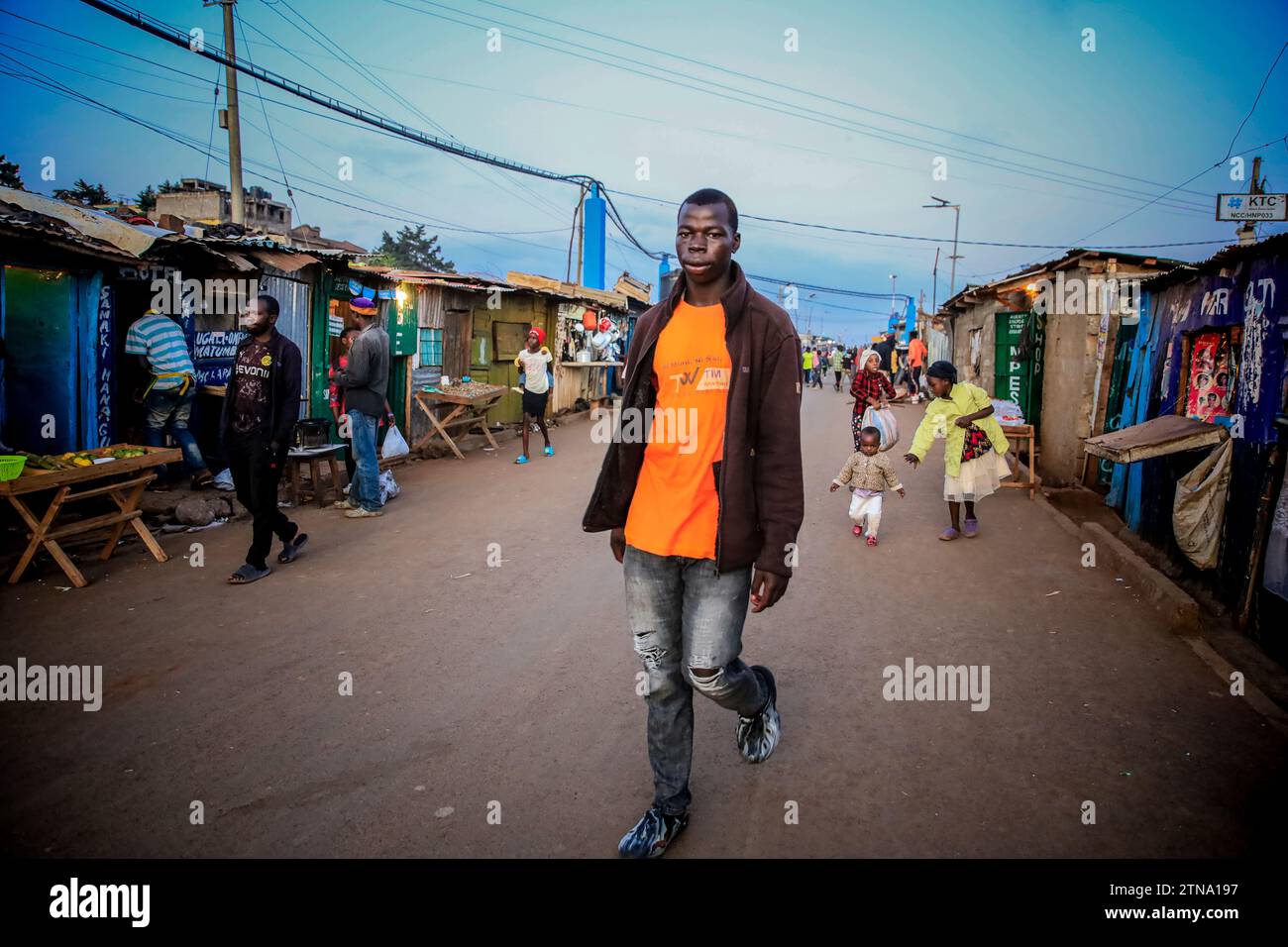 Residents walk past the busy streets in Kibera Slum, Nairobi. A view ...