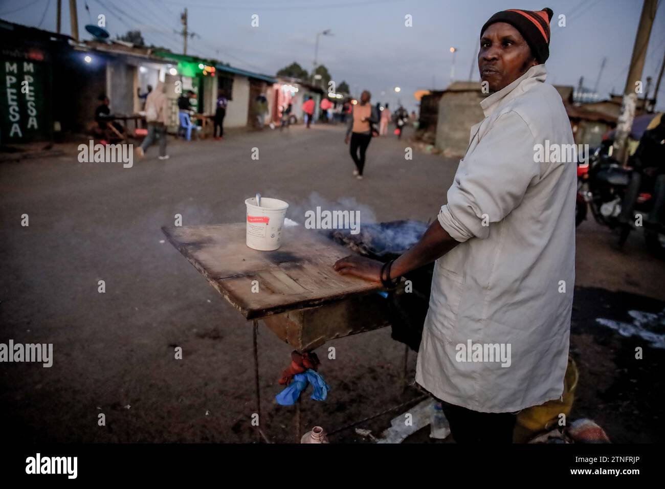 A man selling street food in Kibera Slum, Nairobi. A view through the ...