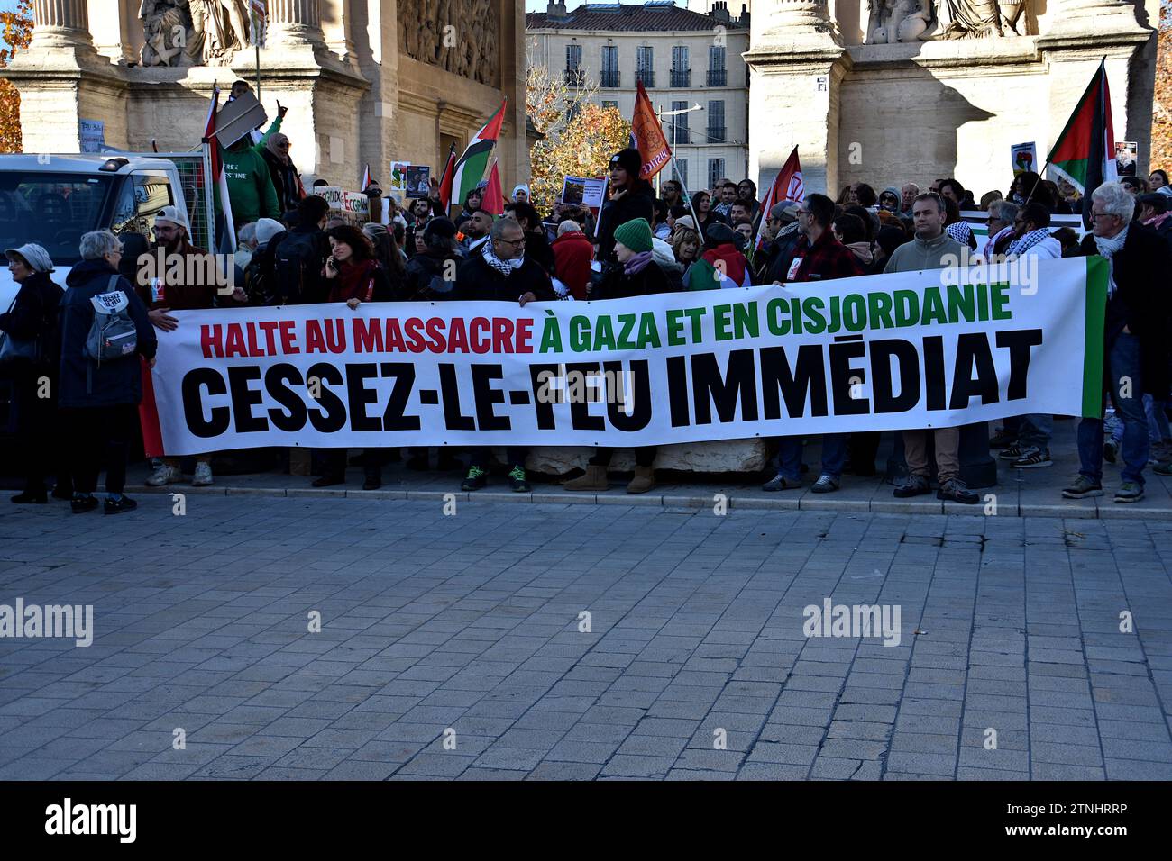 Palestinian protesters hold a banner with inscriptions "stop the ...