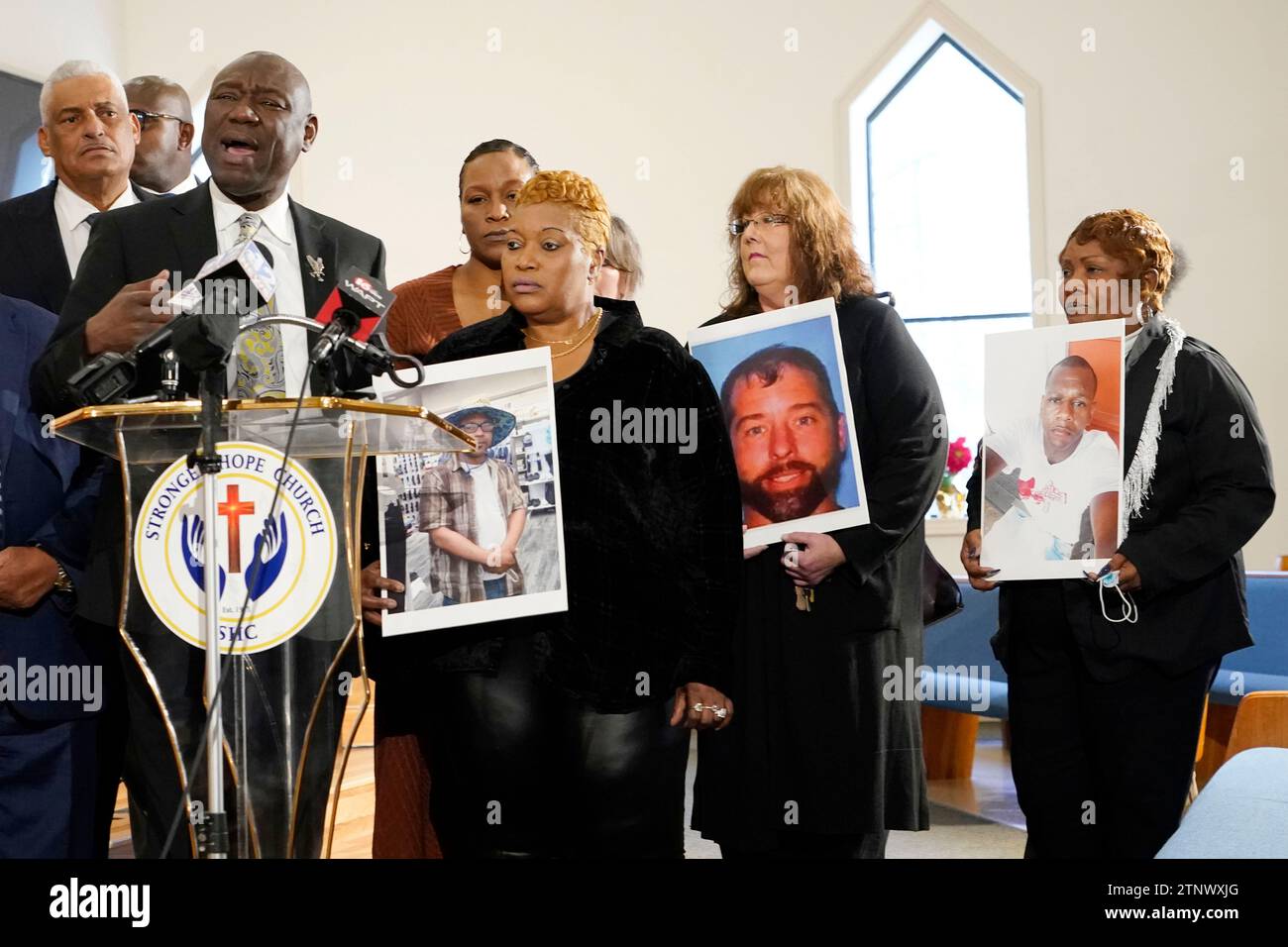 Civil rights attorney Ben Crump, left, stands with the families of ...