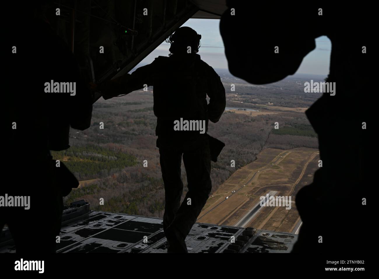 A SERE specialist prepares to jump from a C-130J Super Hercules over ...