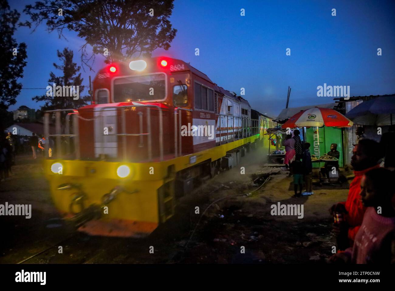The late evening Nairobi to Kisumu passenger train drives past Kibera ...