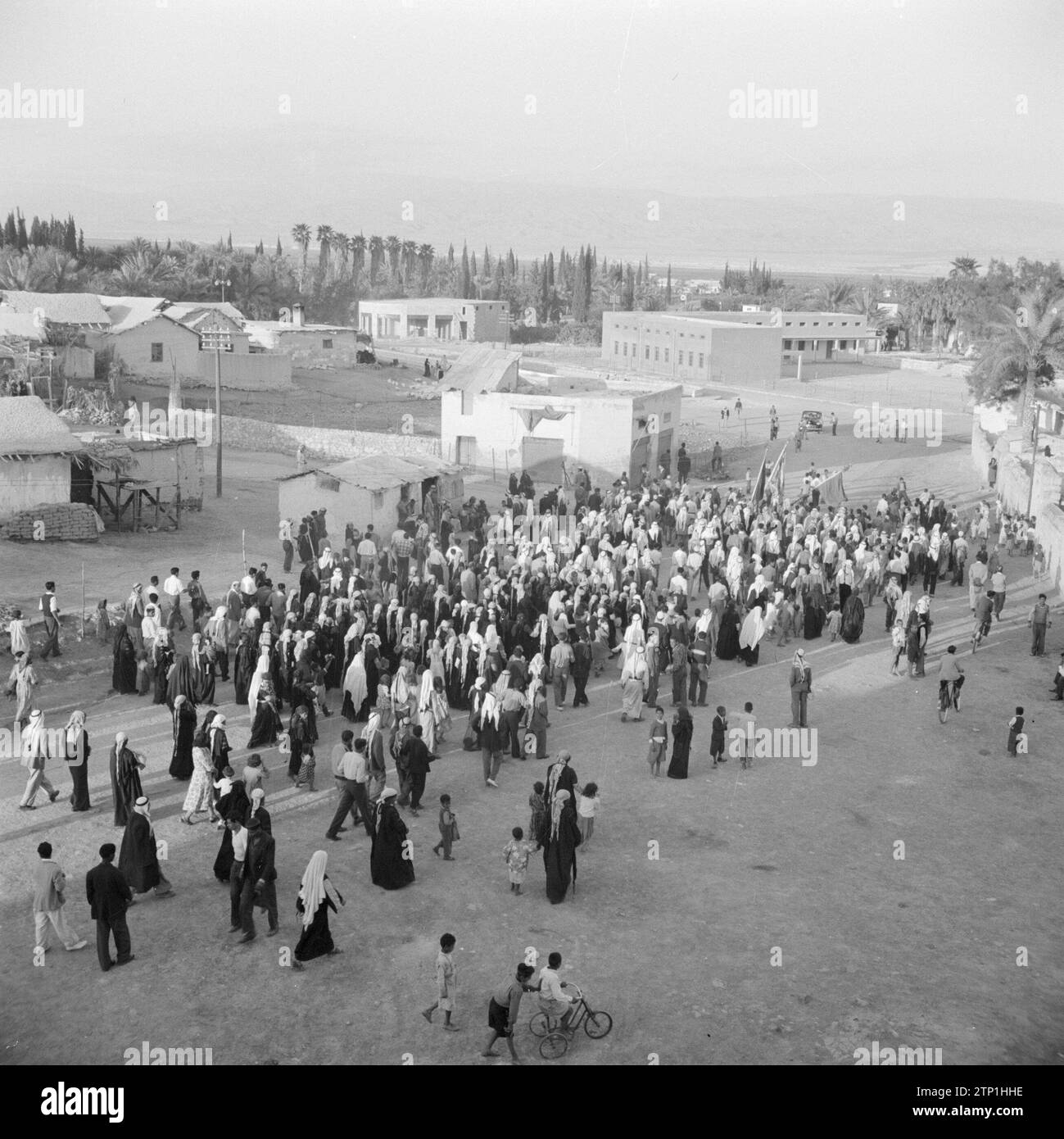 Street scene in Jericho with a procession of people seen from above ca ...
