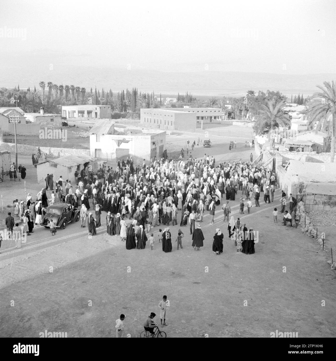 Street scene in Jericho with a procession of people seen from above ca ...