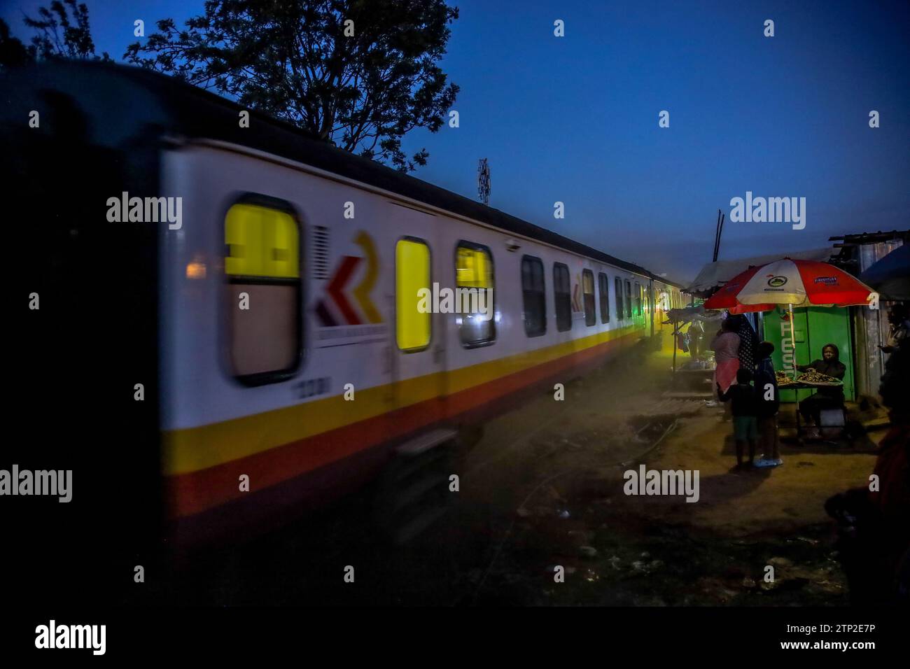 The late evening Nairobi to Kisumu passenger train drives past Kibera ...
