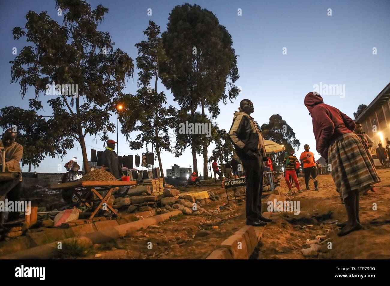 Residents walk past the busy business streets in Kibera Slum, Nairobi ...