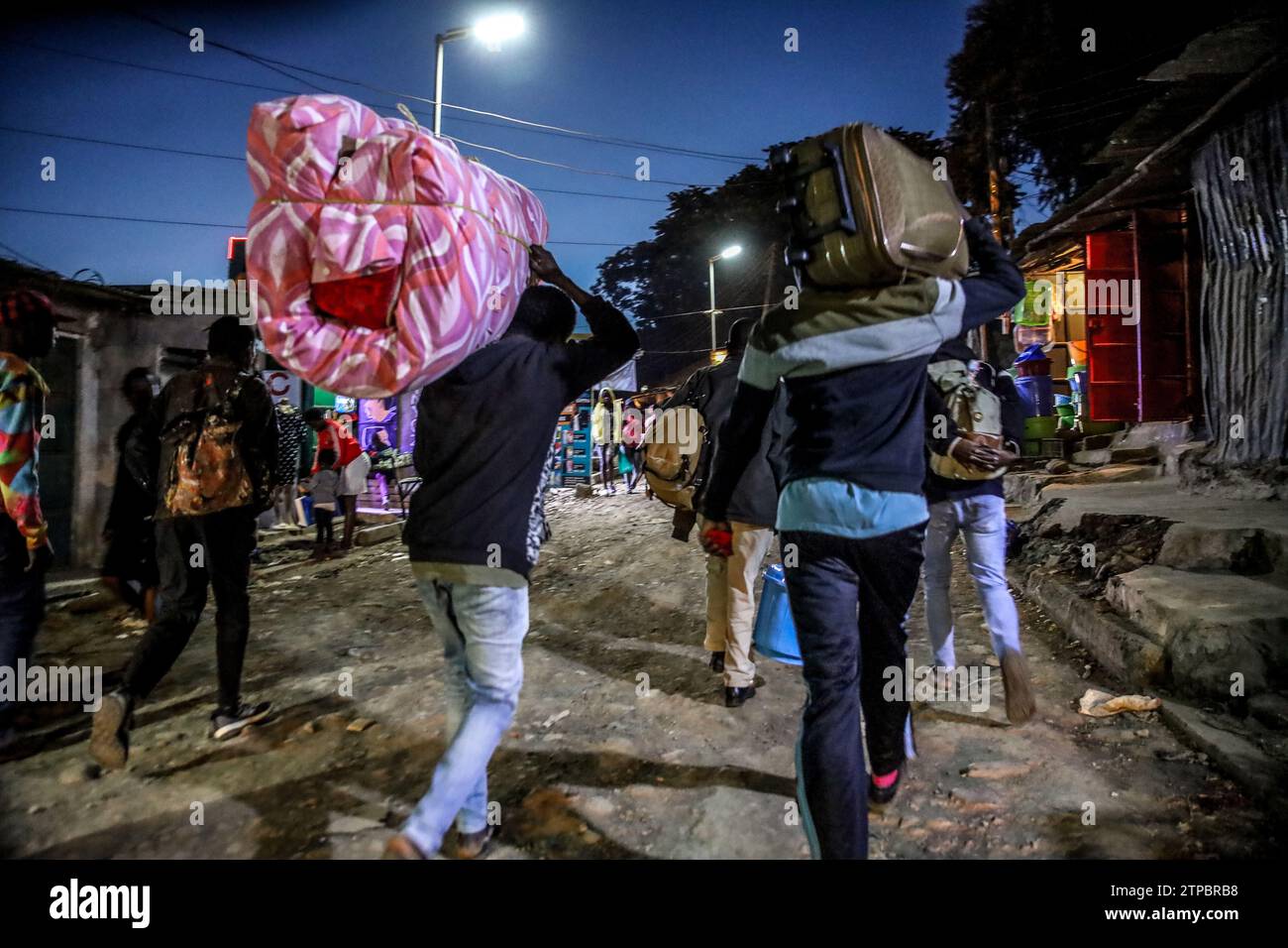 Pedestrians walk past the busy streets in Kibera Slum, Nairobi. A view ...
